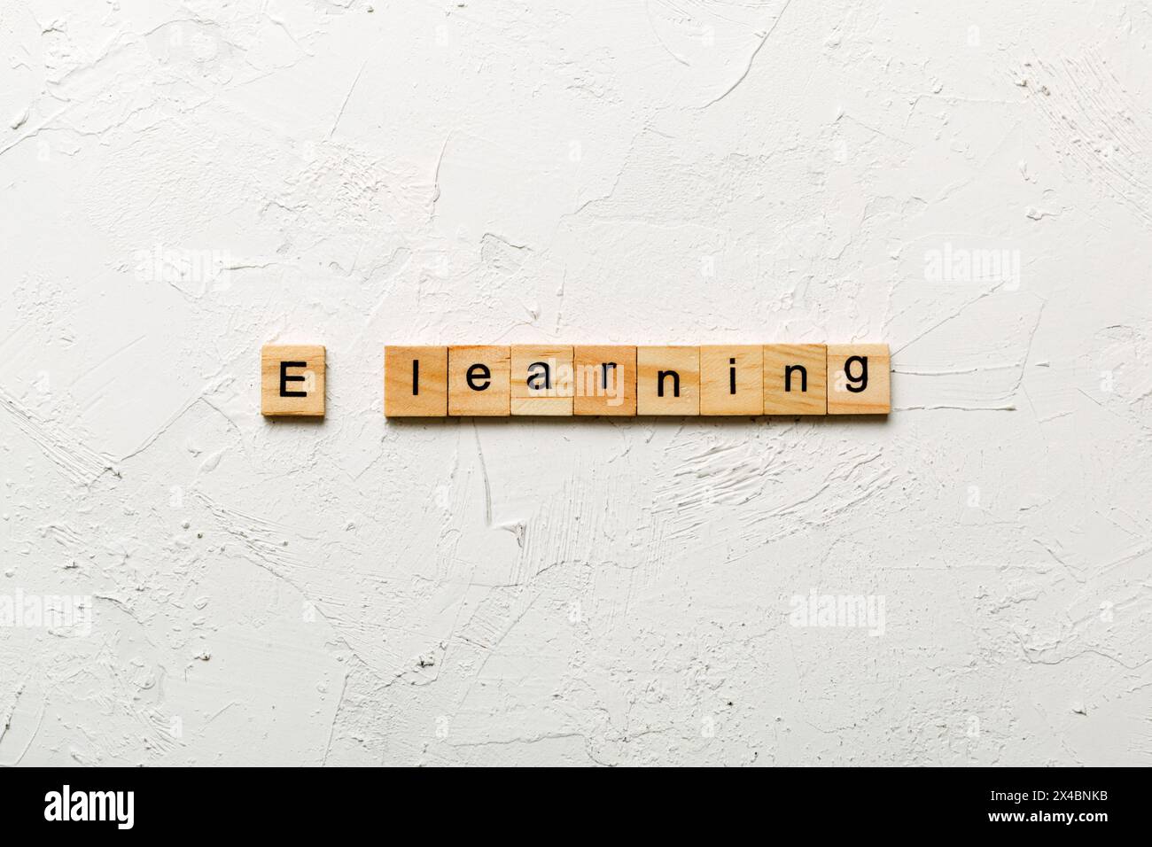 E learning word written on wood block. Elearning text on cement table ...