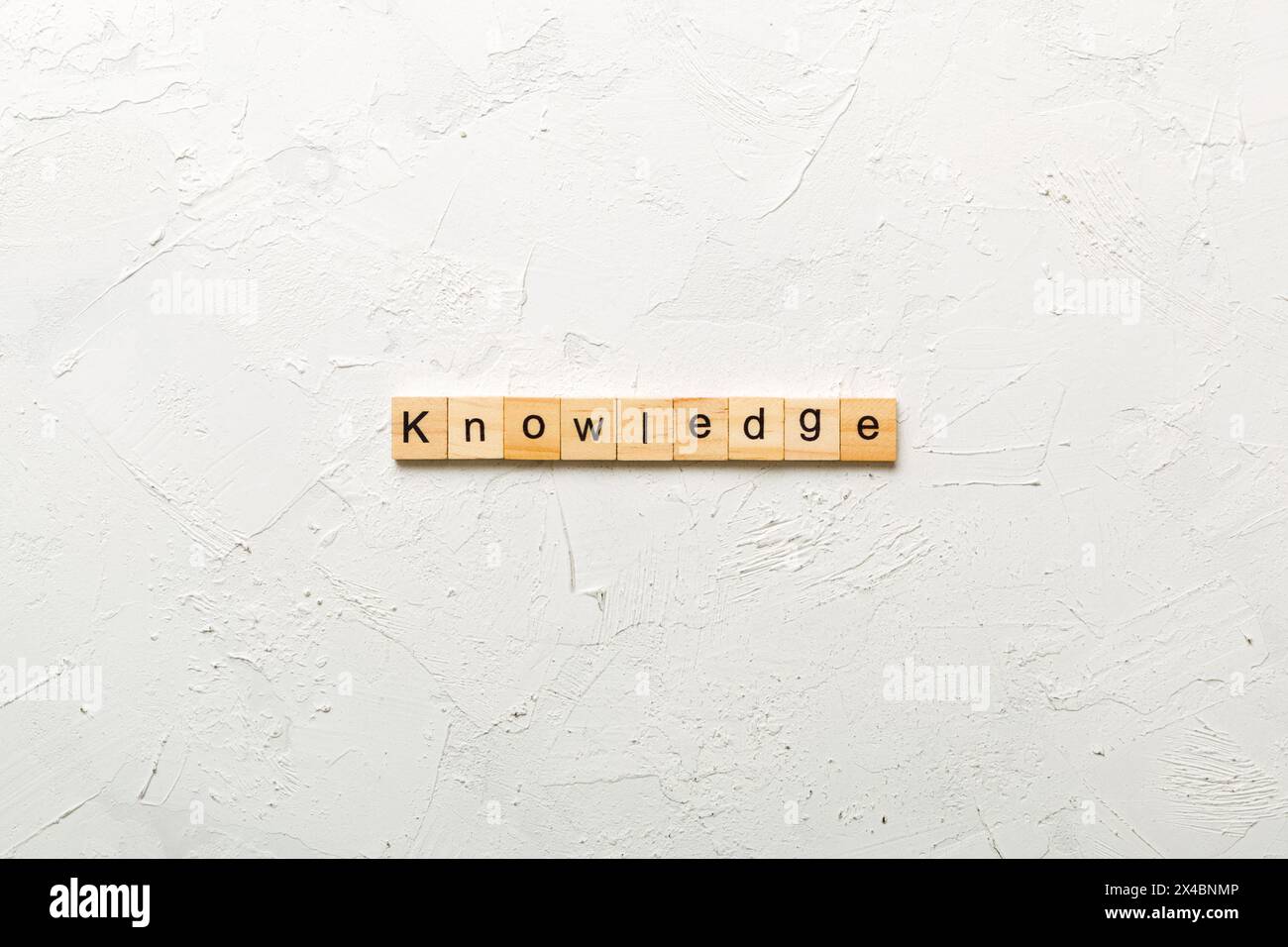 Knowledge word written on wood block. Knowledge text on cement table ...