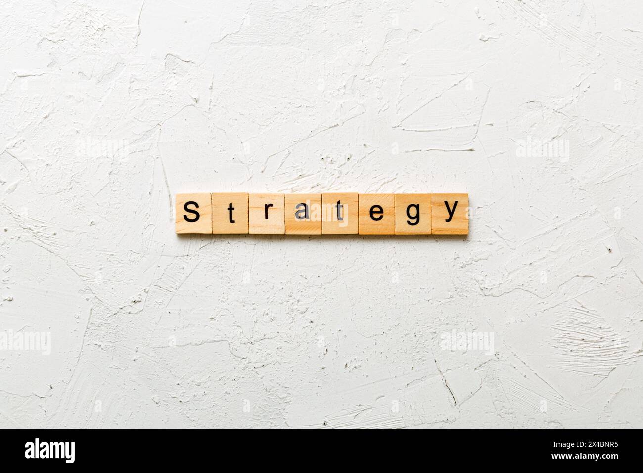 STRATEGY word written on wood block. STRATEGY text on cement table for ...
