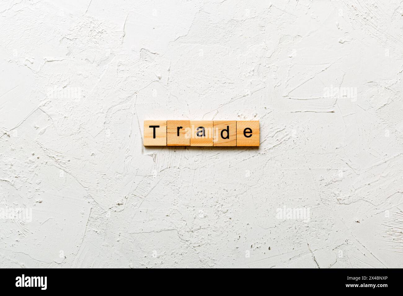 Trade word written on wood block. Trade text on cement table for your ...