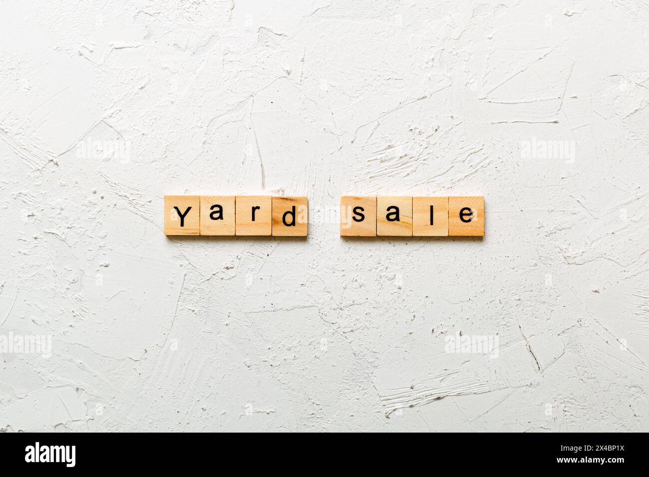 Yard sale word written on wood block. Yard sale text on cement table ...