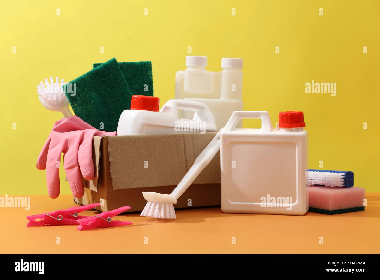 Front view of set of different detergents displayed on a yellow ...