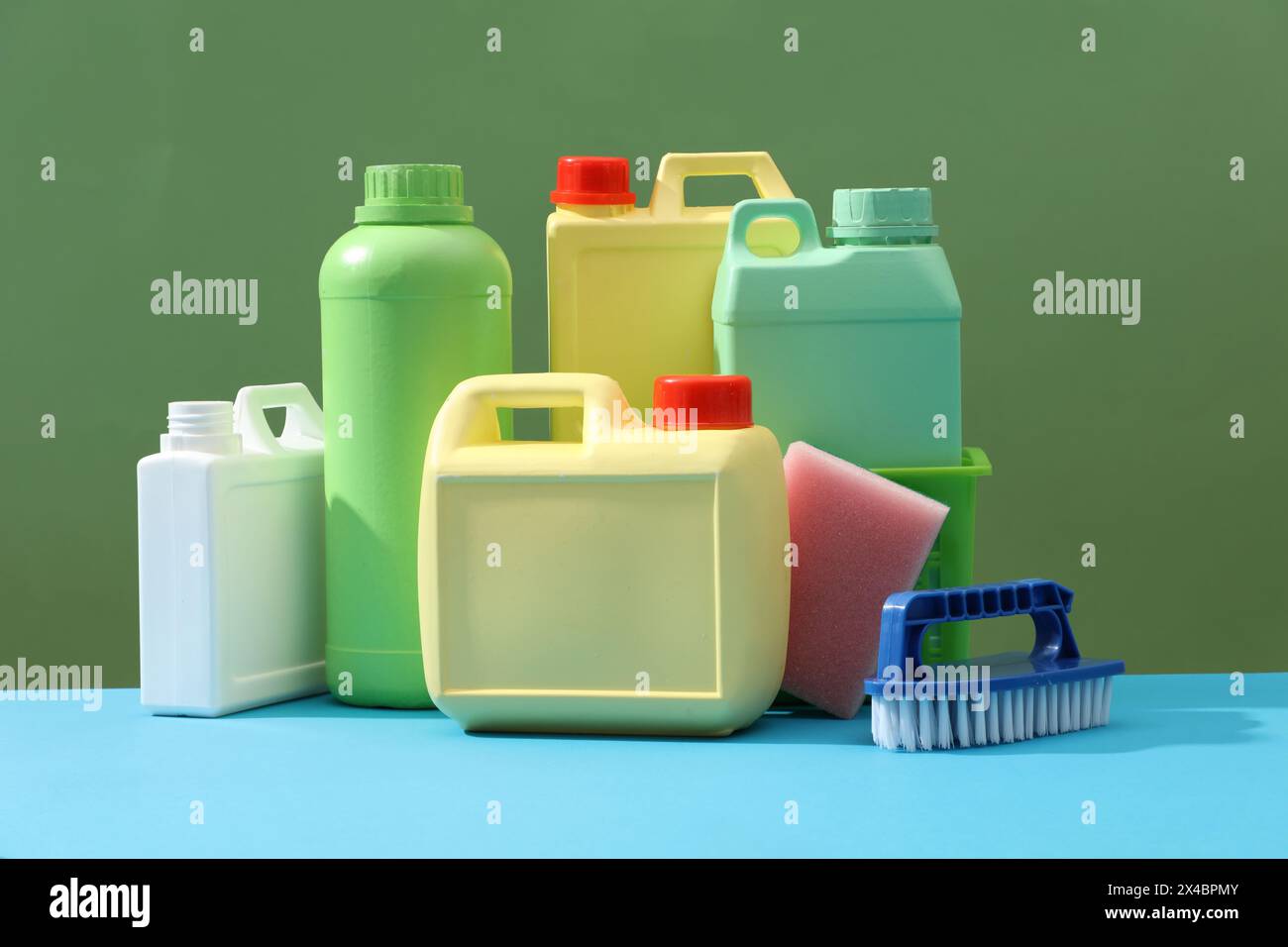 On a dark green background, set of different plastic canister and ...
