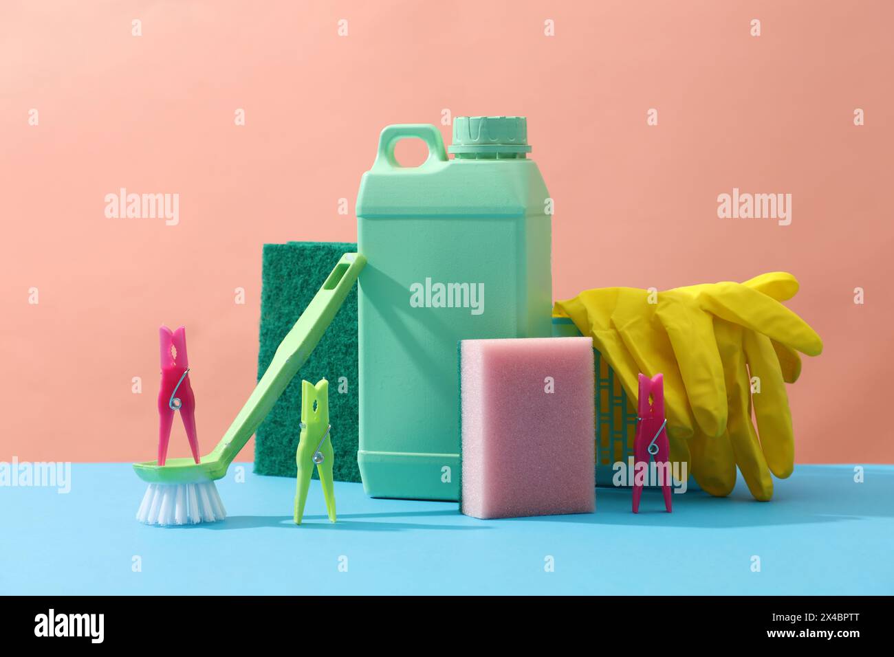 House cleaning plastic product on pink background and blue plain with ...