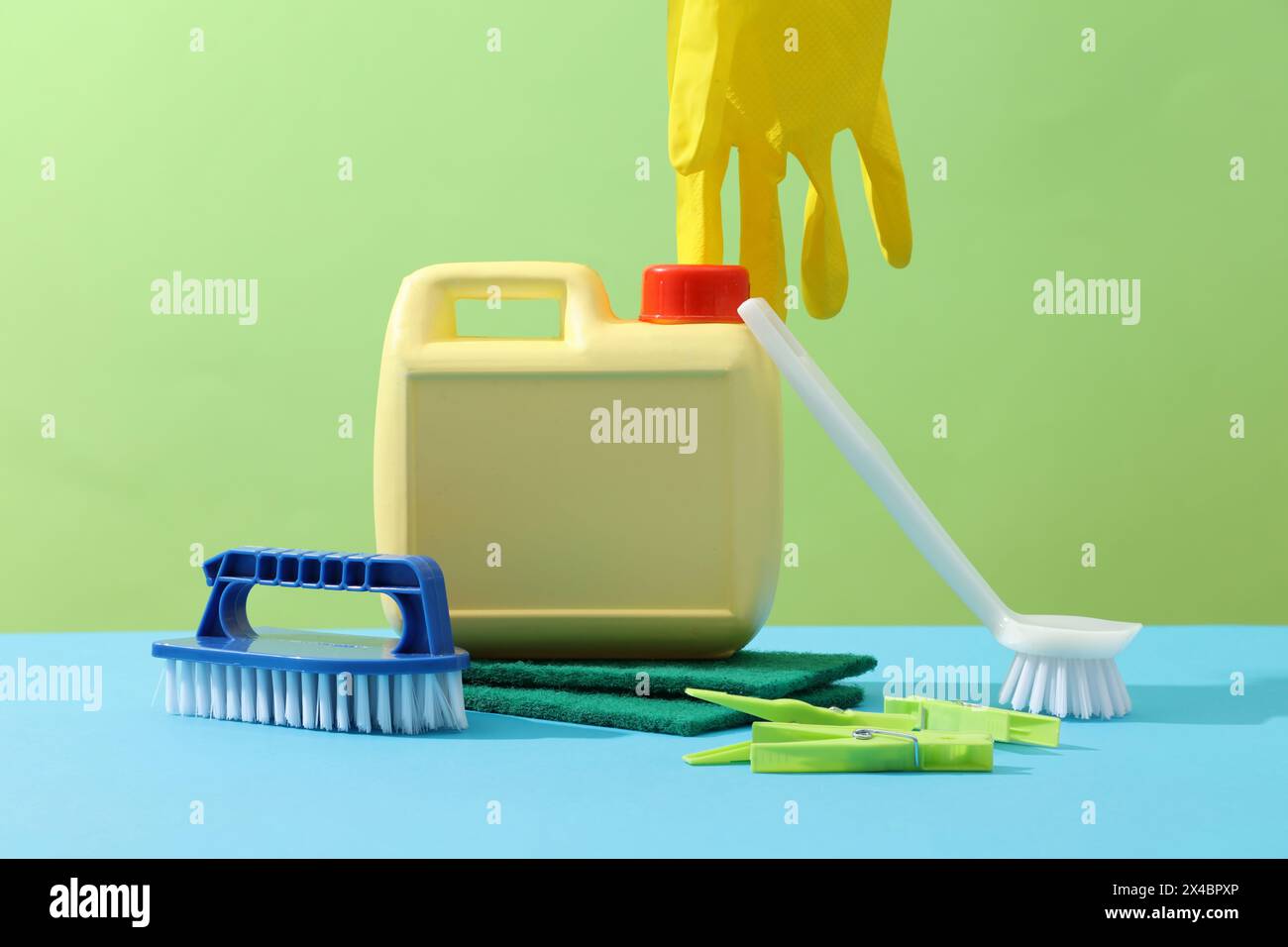 Yellow detergent canister with brushes, clothespins and glove decorated ...