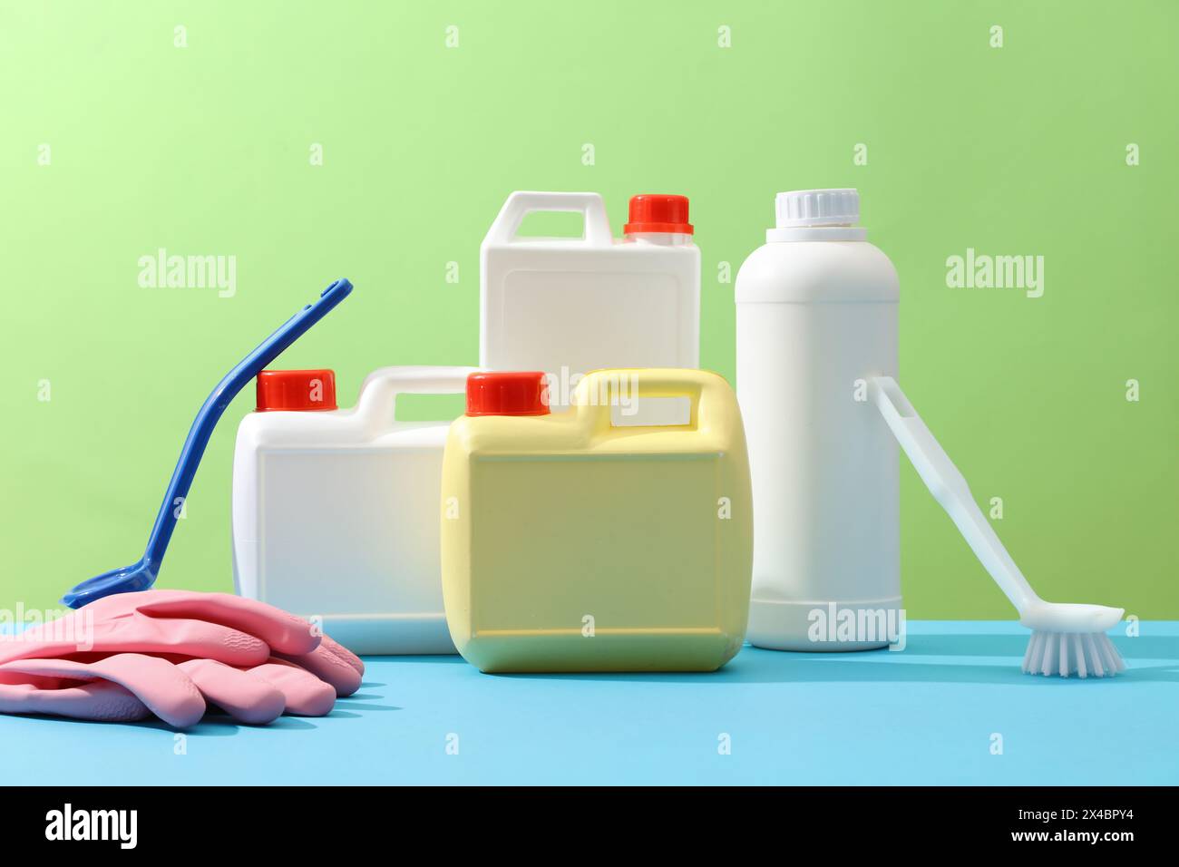 Colorful cleaning products decorated on green background. Set of ...