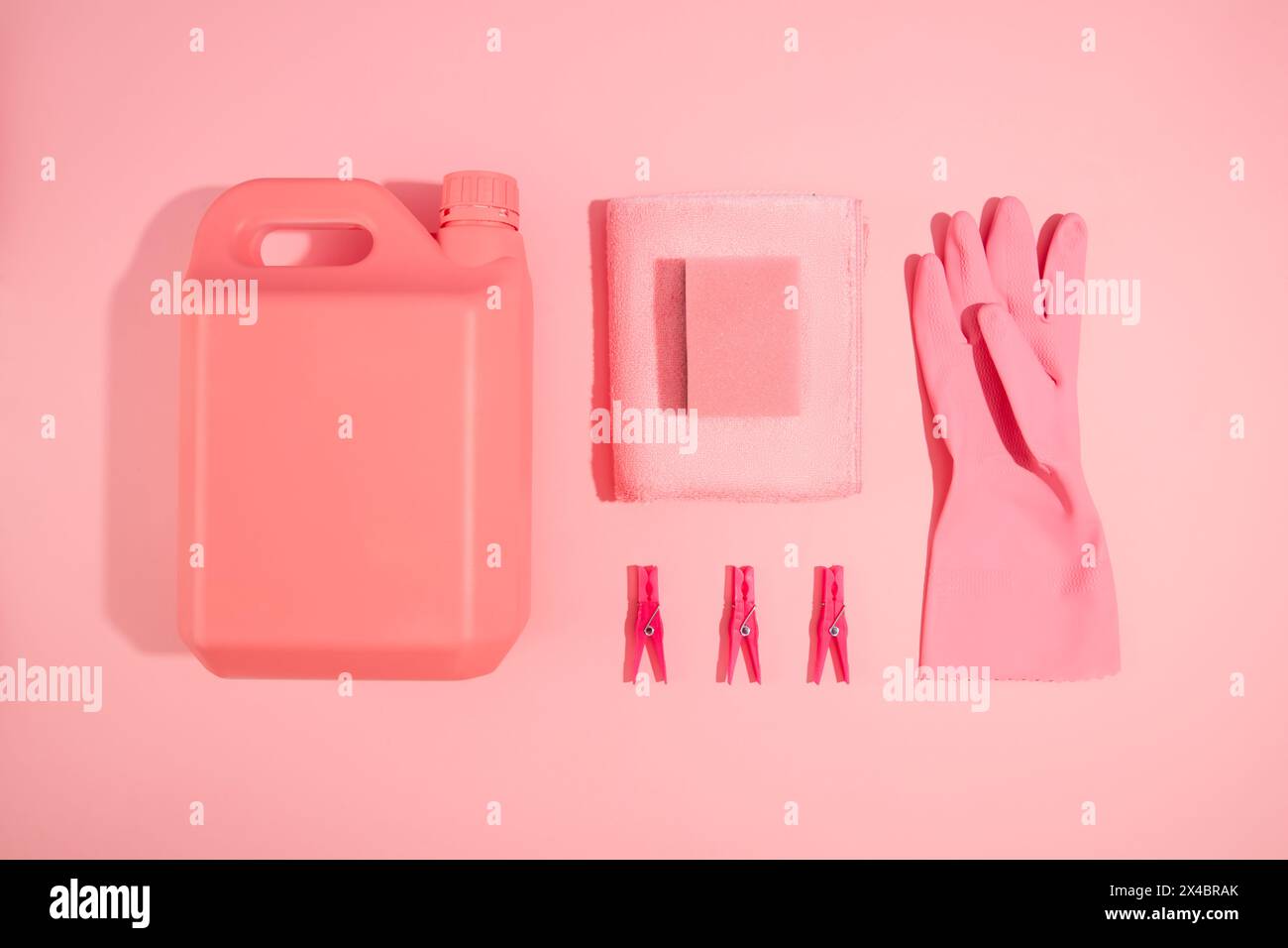 Top view of set of different detergents displayed on a pink background ...