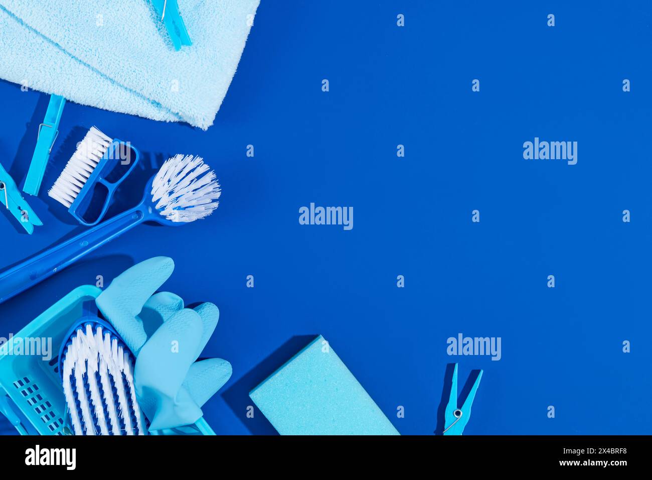 Cleaning tools displayed on a blue background with brushes, rubber ...