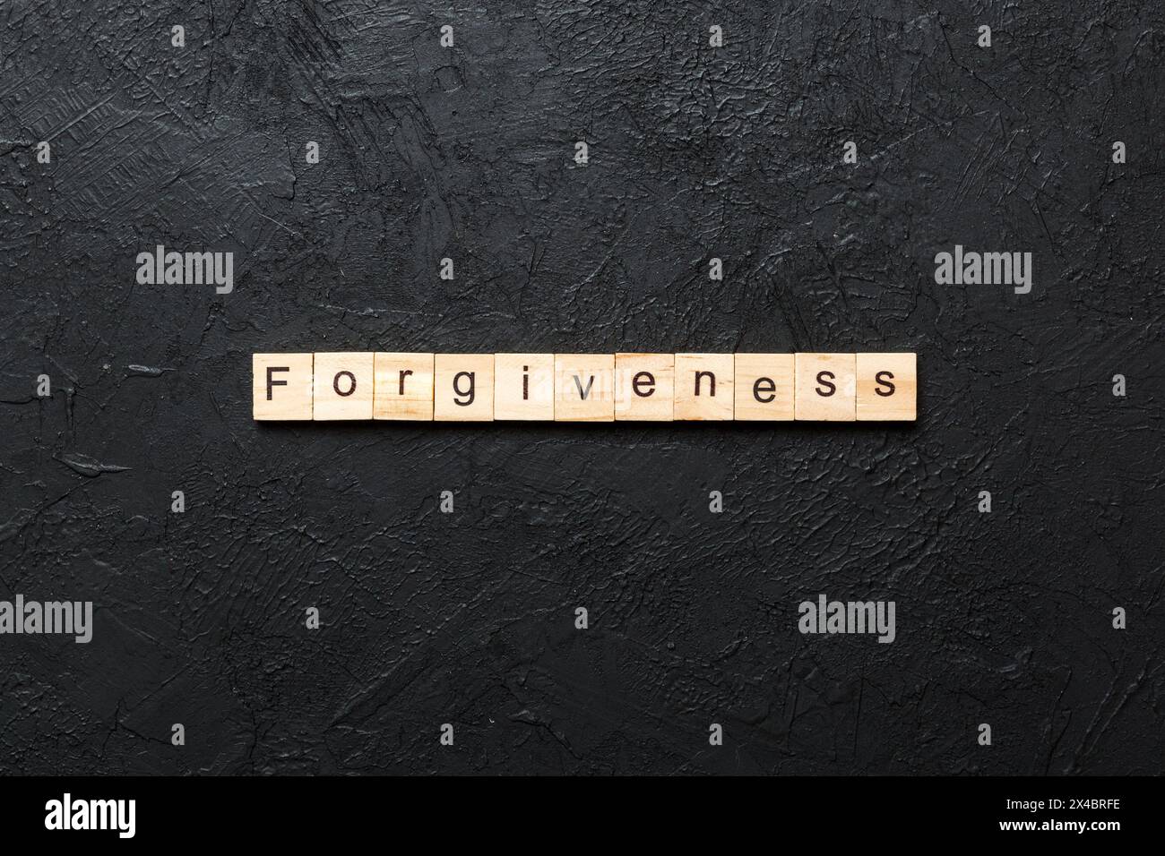 forgiveness word written on wood block. forgiveness text on table ...