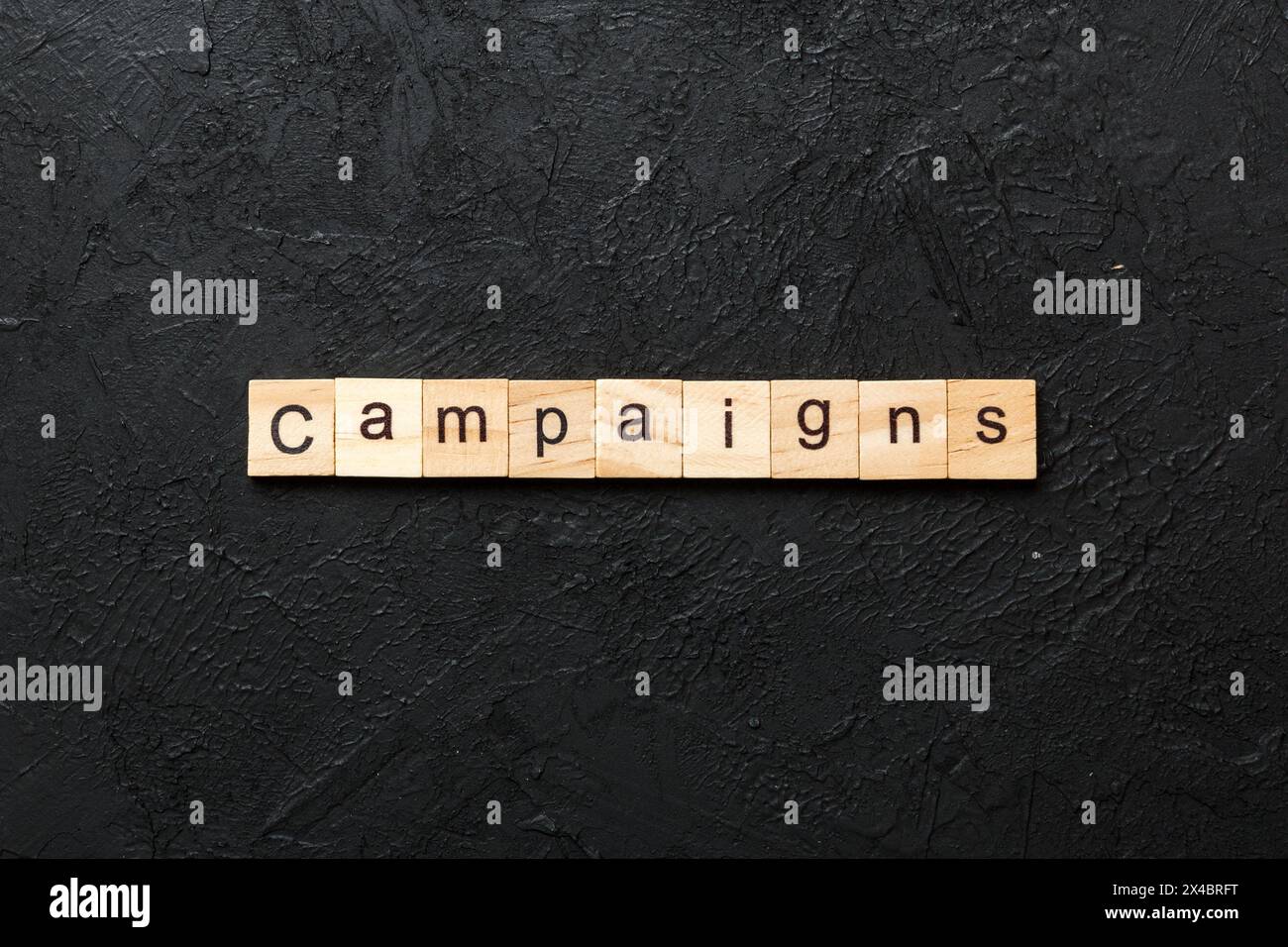 campaigns word written on wood block. campaigns text on table, concept ...