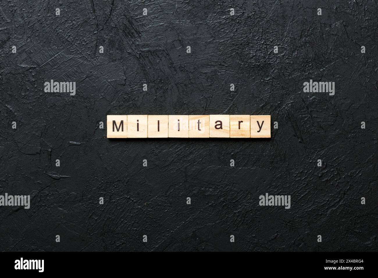 MILITARY word written on wood block. MILITARY text on cement table for ...