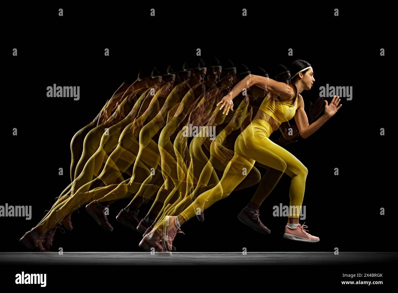 Athletic young woman in full motion, training, running against black ...