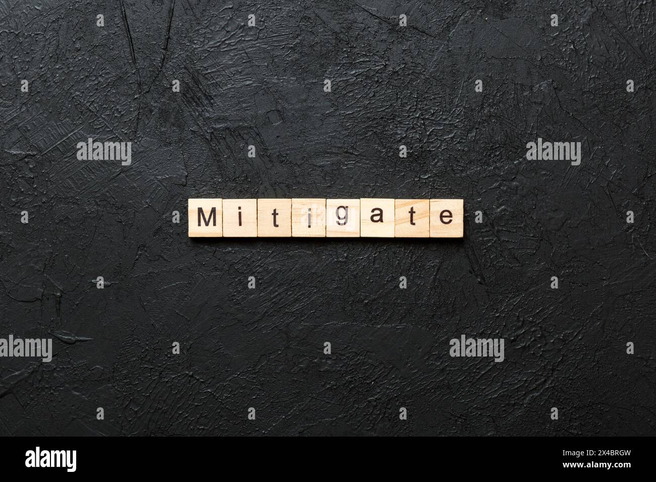 mitigate word written on wood block. mitigate text on table, concept ...