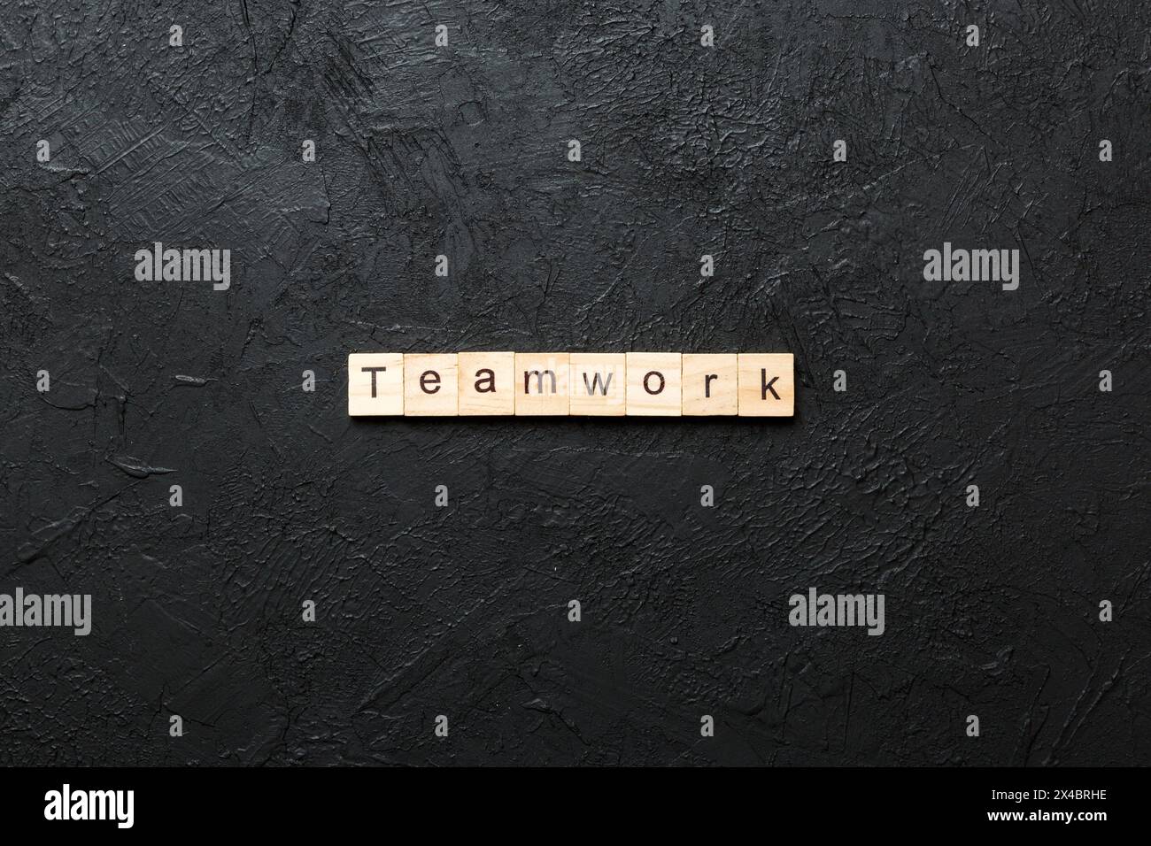 TEAMWORK word written on wood block. TEAMWORK text on cement table for your desing, concept ...