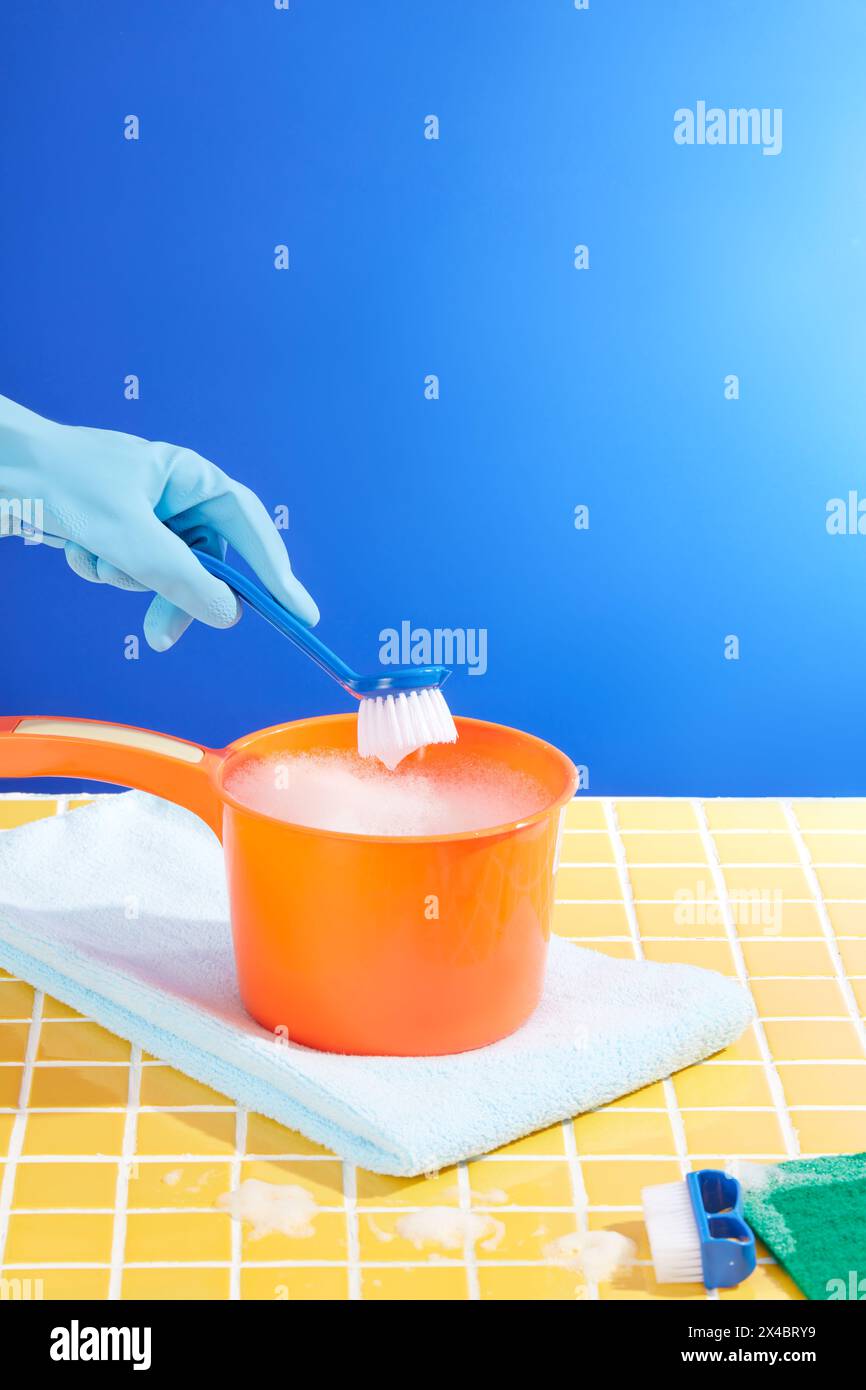 Front view of orange plastic water dipper container cleaning foam and ...