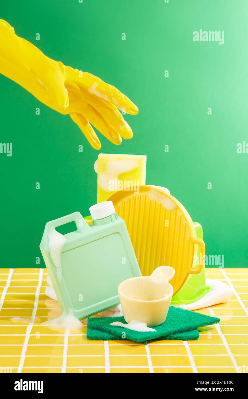Bowl, pan and bottle being cleaned with soap bubbles on the surface ...