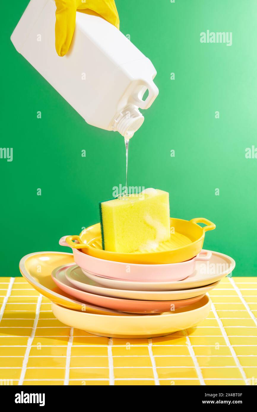 Stacks of ceramic dishes and pans washed on the yellow tile floor. A ...