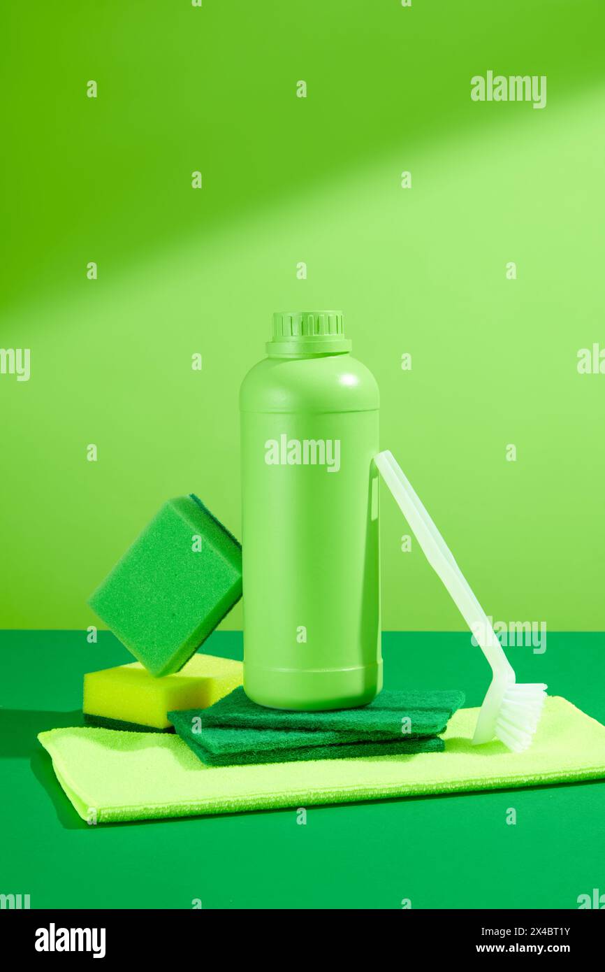 House cleaning plastic product on green background with detergents ...