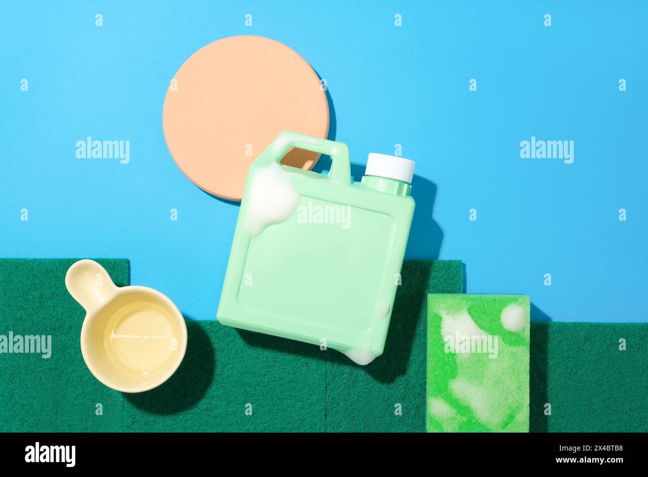 Unlabeled detergent bottle shines on a blue background amid cleaning ...