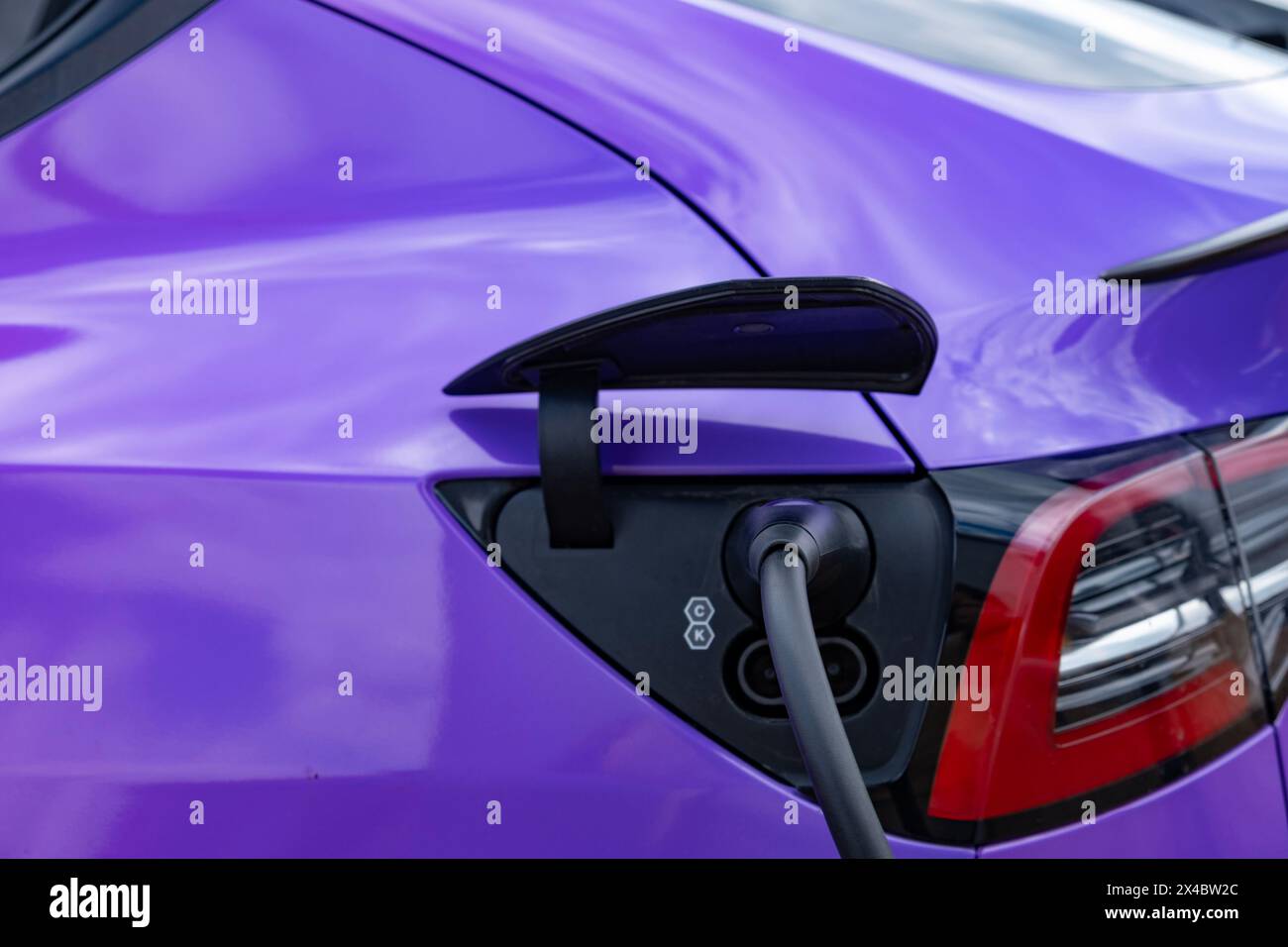 close-up detail lilac Tesla Model Y electric car replenishes battery ...