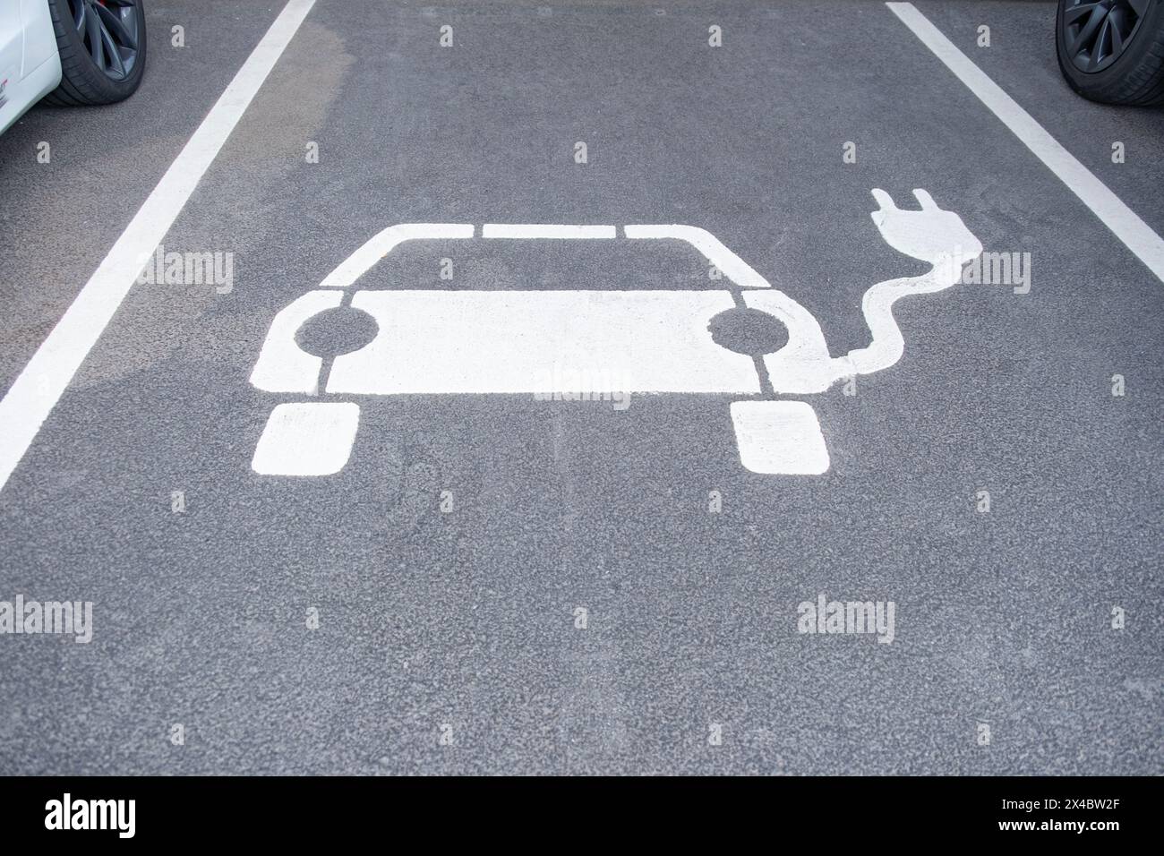 white electric vehicle sign painted on asphalt, charging station, Power ...