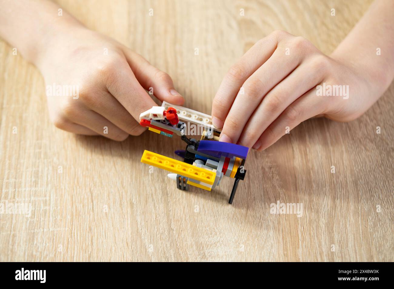 boy created and manipulates with transformer robot, child plays with ...