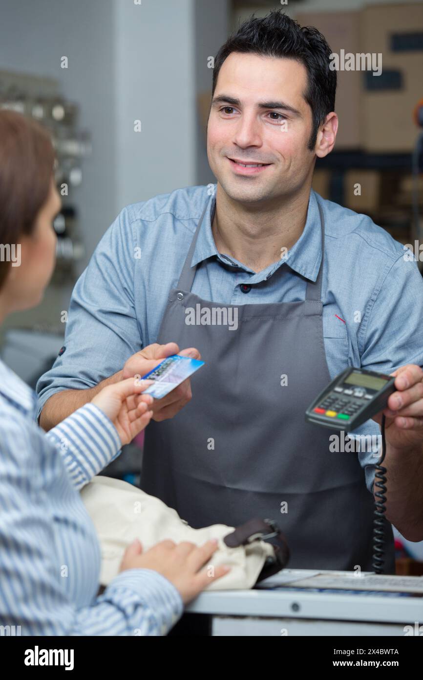 client giving her card for service payment Stock Photo - Alamy