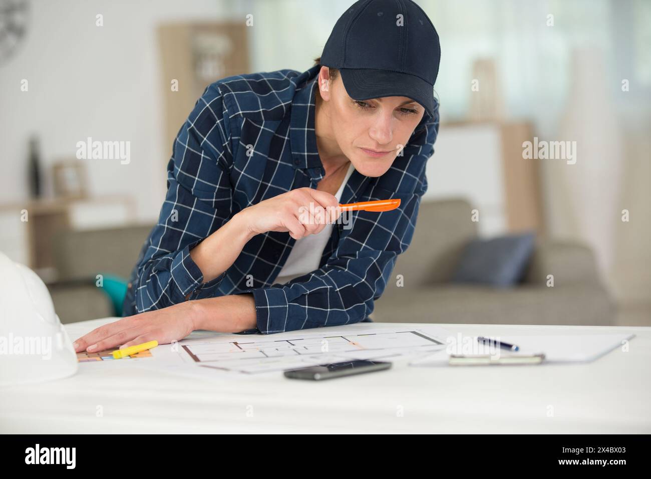 female engineer reading a map Stock Photo - Alamy