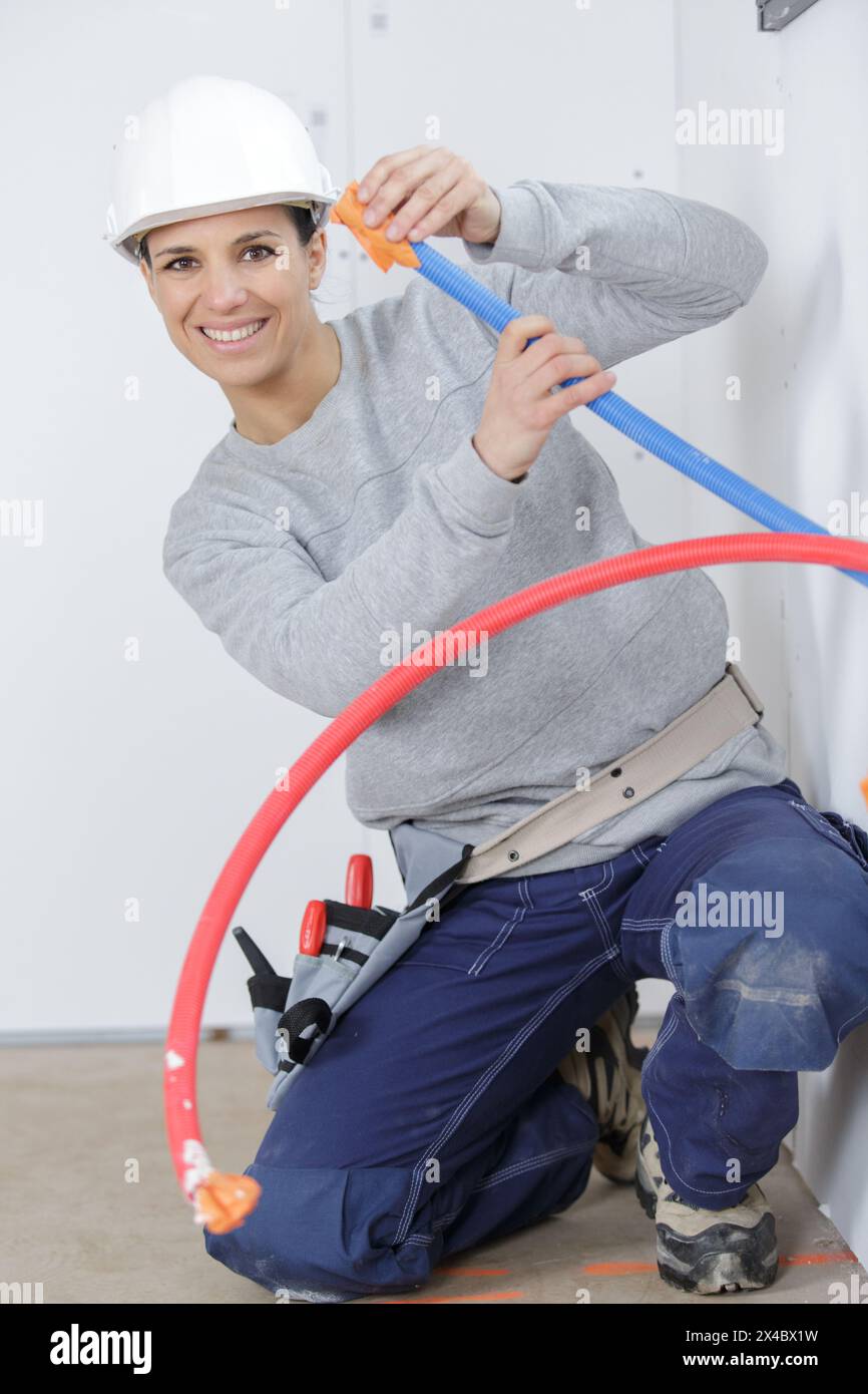 positive woman worker installing cables Stock Photo - Alamy