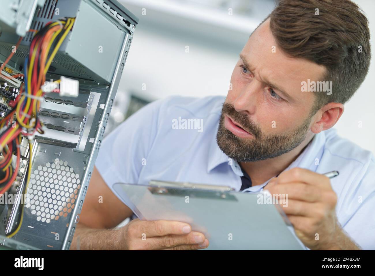 male technician checking the state of an old pc Stock Photo - Alamy