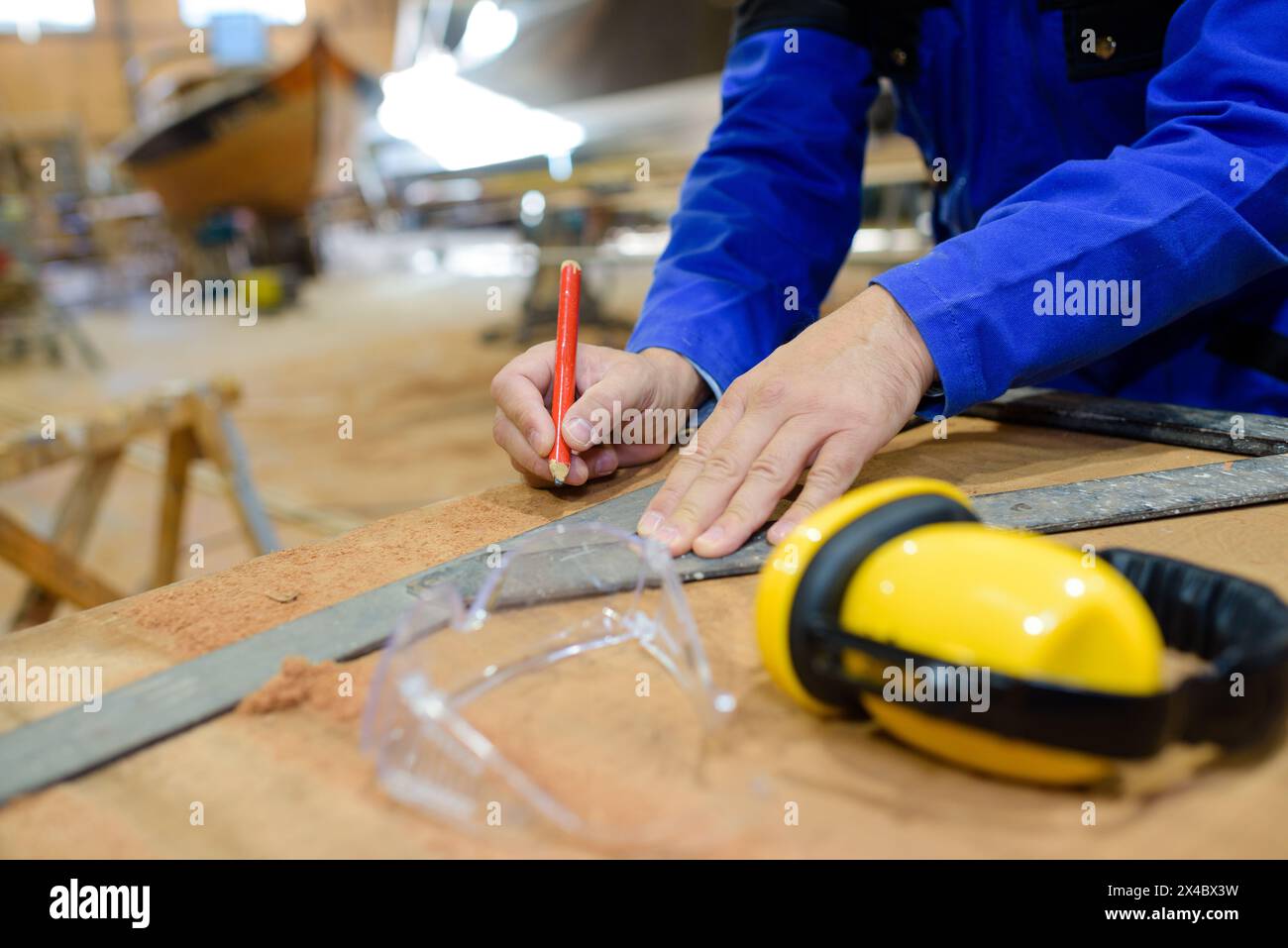 a hand measuring a plywood Stock Photo - Alamy