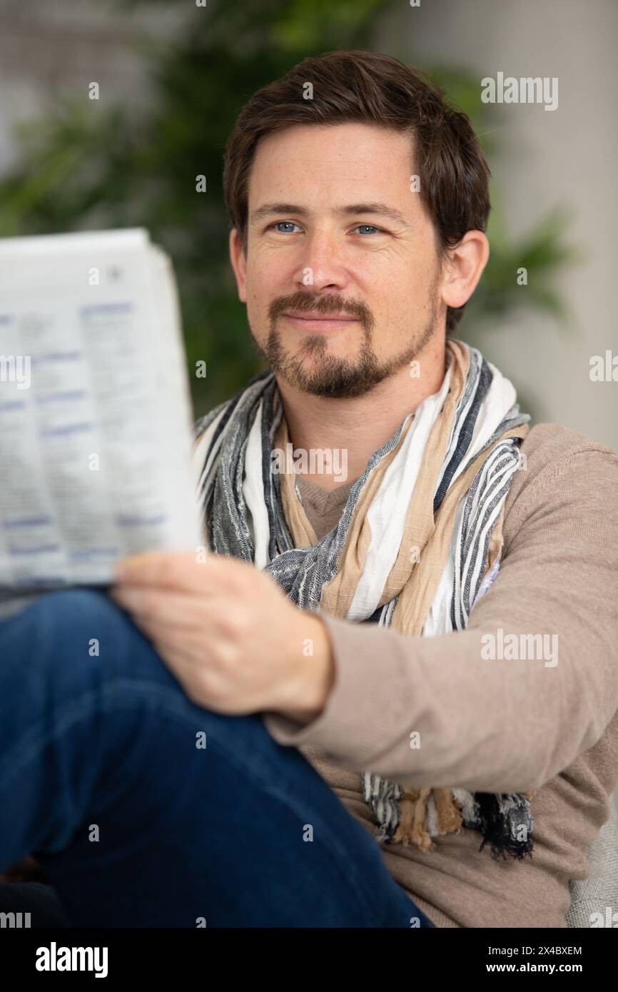happy young man with newspaper Stock Photo - Alamy