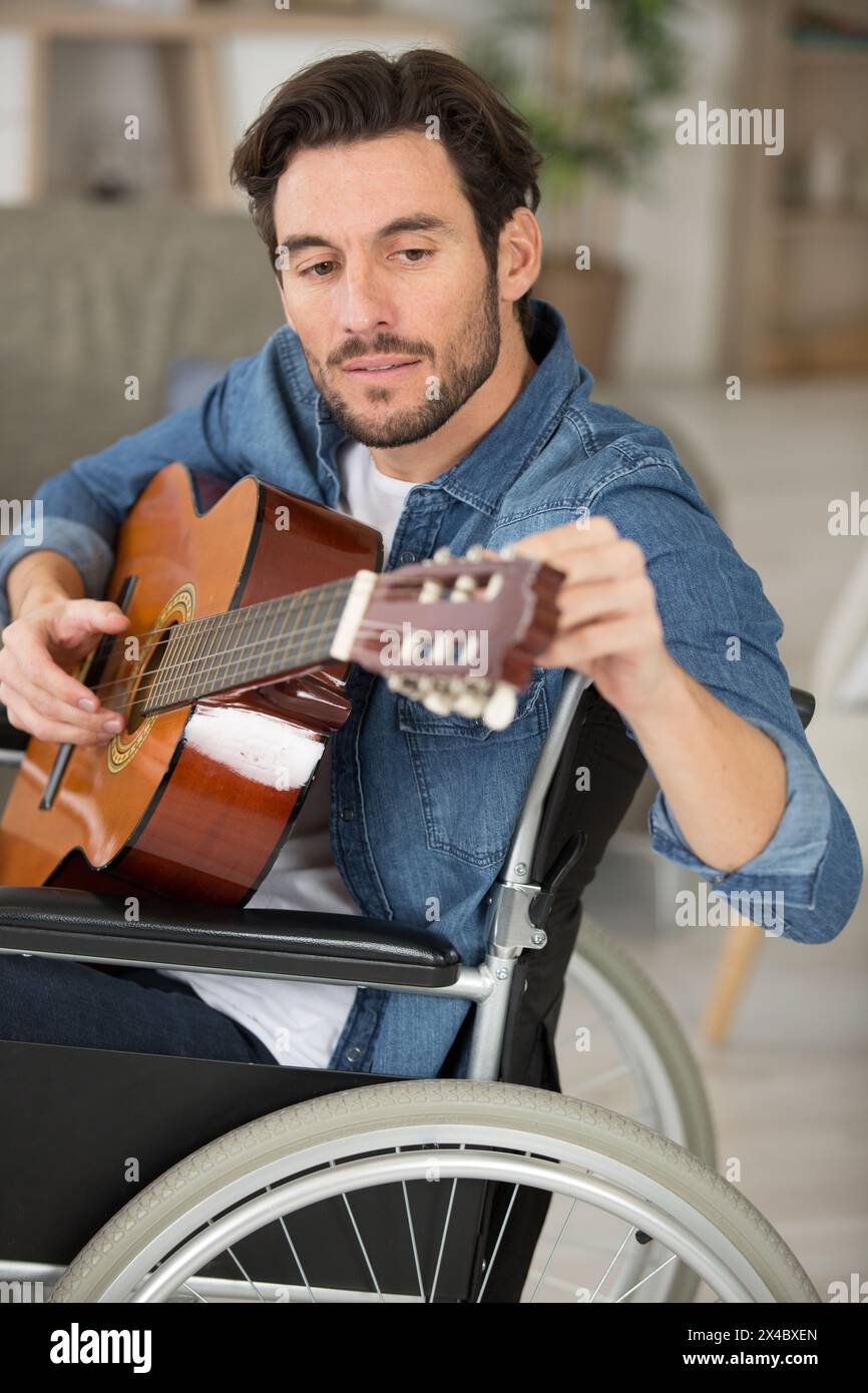 disabled man playing guitar at home Stock Photo - Alamy