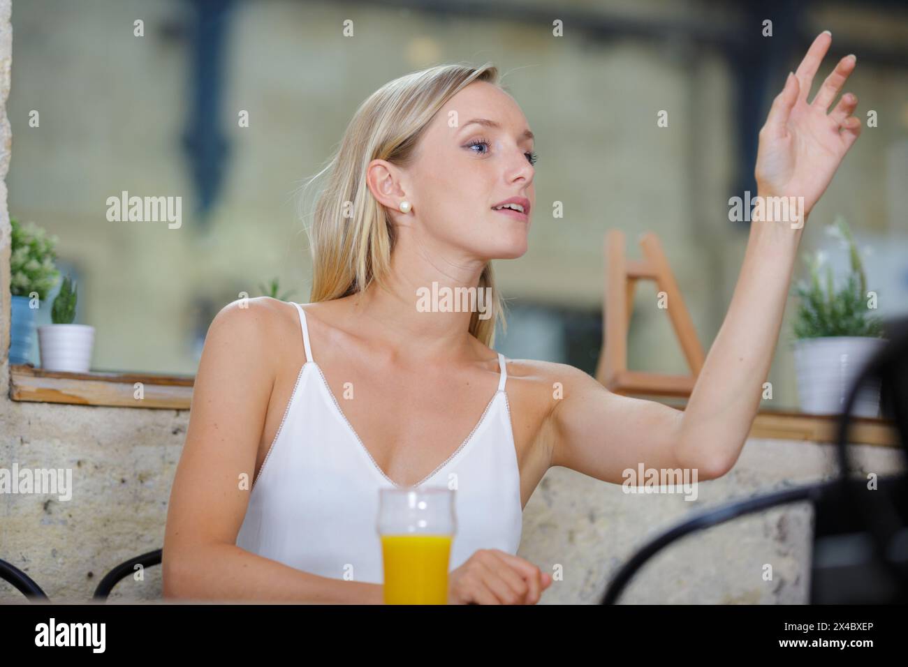 Woman calling waiter hi-res stock photography and images - Alamy