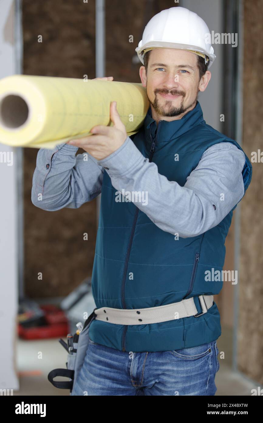 portraot of builder carrying materials on his shoulder Stock Photo - Alamy