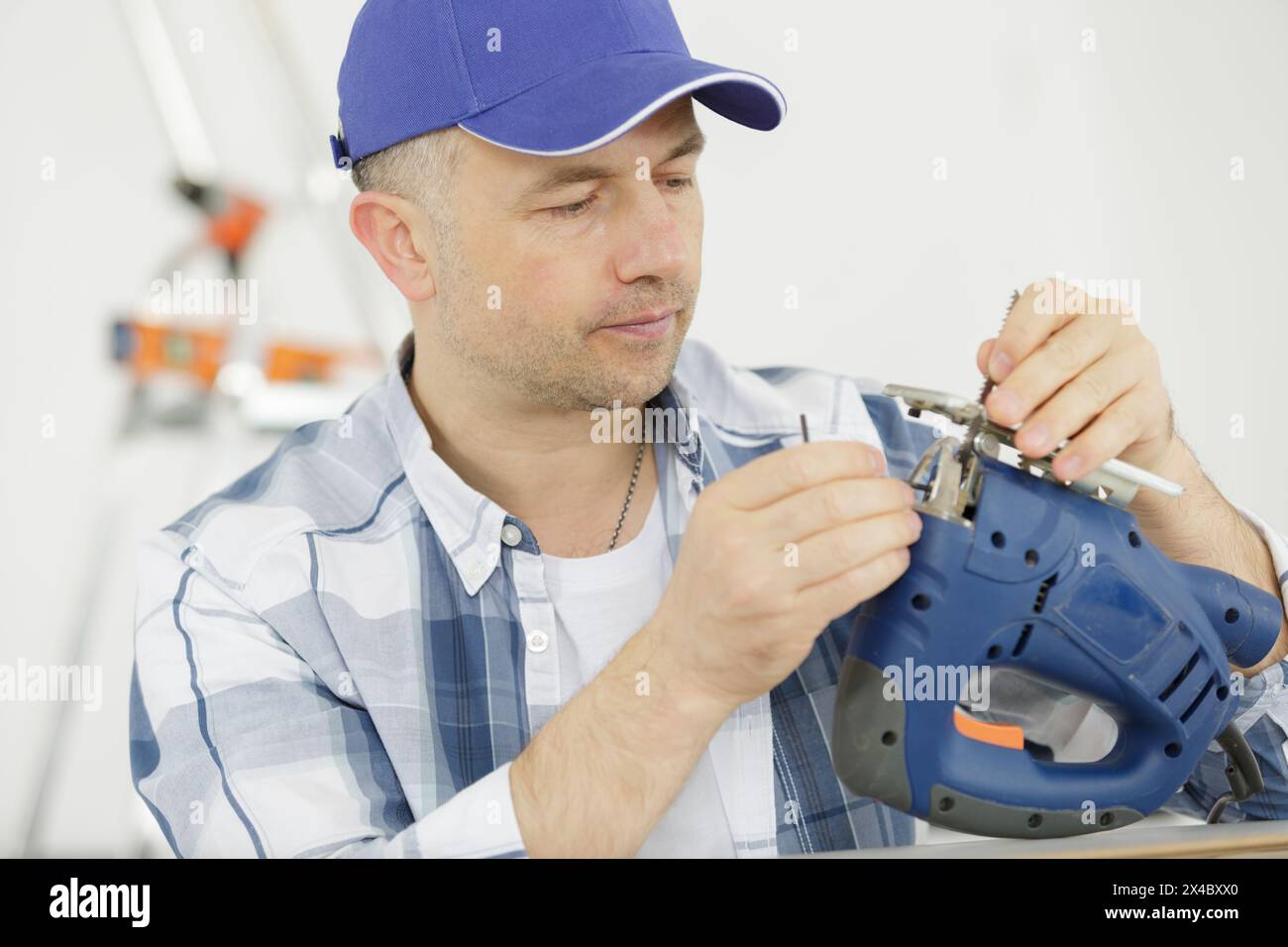 man fixing a broken wood cutter Stock Photo - Alamy