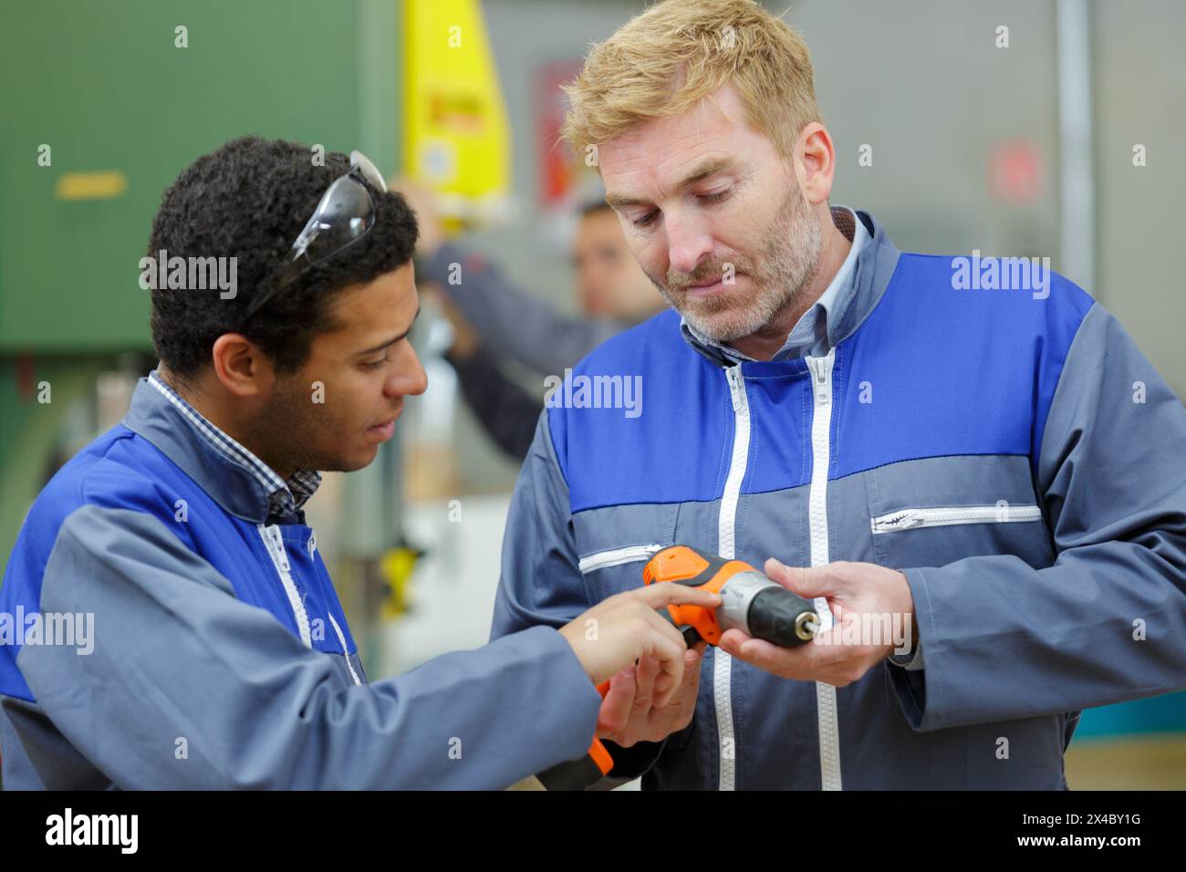 apprentice engineer asking question about cordless screwdriver Stock ...