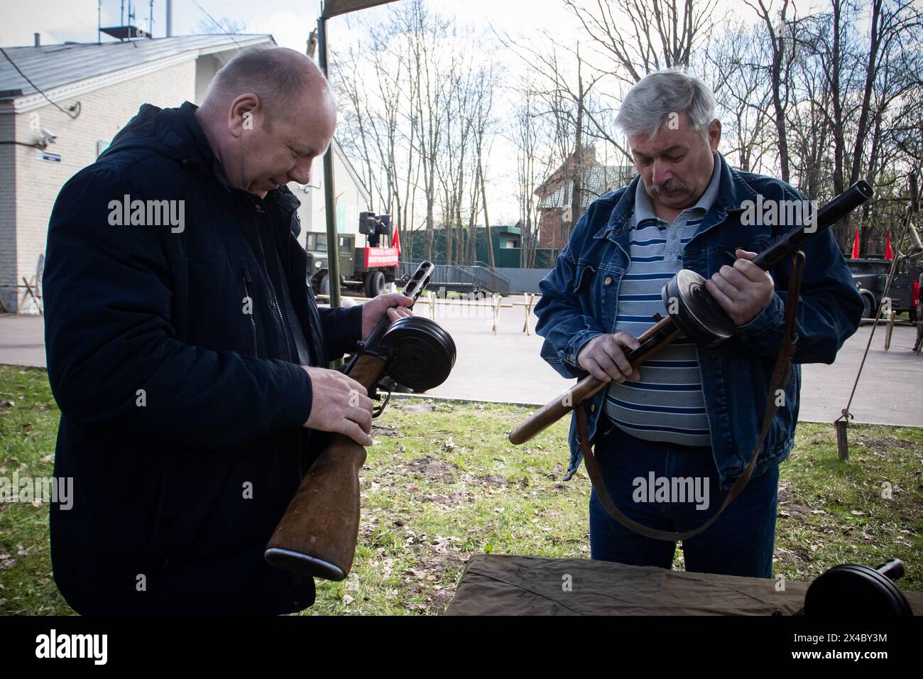 Participants examine examples of a Shpagin submachine gun during the ...