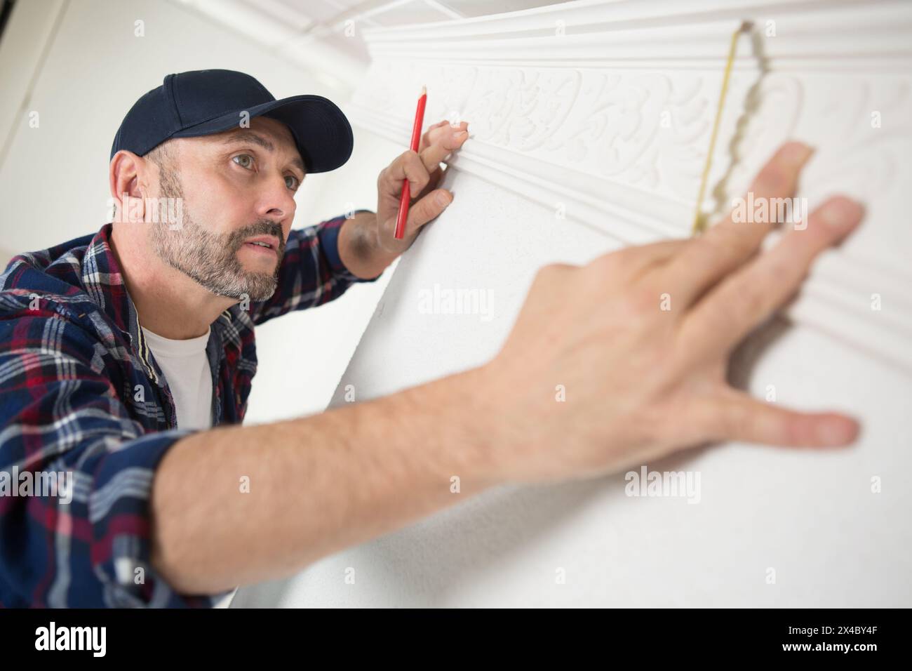fixing plinth between ceiling and walls Stock Photo - Alamy