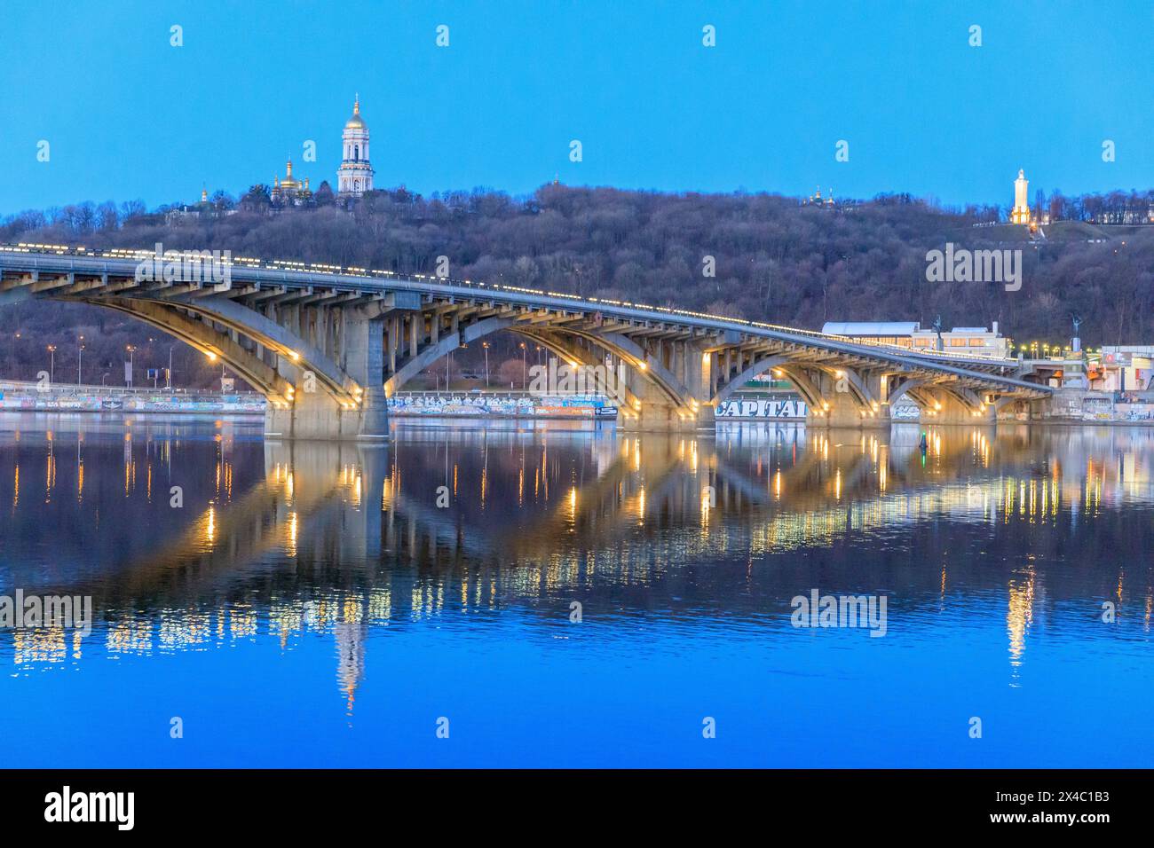 Ukraine, Kiev, Kyiv. Metro Bridge across the Dnieper River. Roofs of ...
