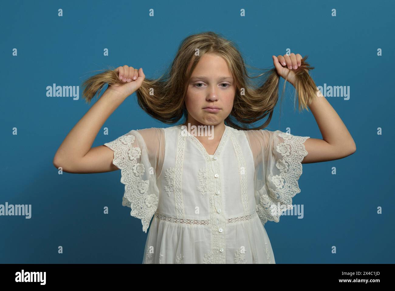 Hair length. It's a pity to cut off long hair. teenage girl in thought ...
