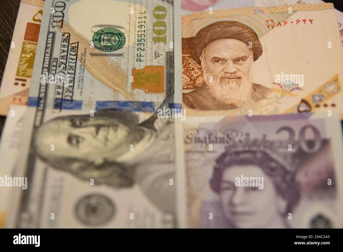 In this photo, you can see a 5000 Iranian Rial note, a 100 US Dollar ...