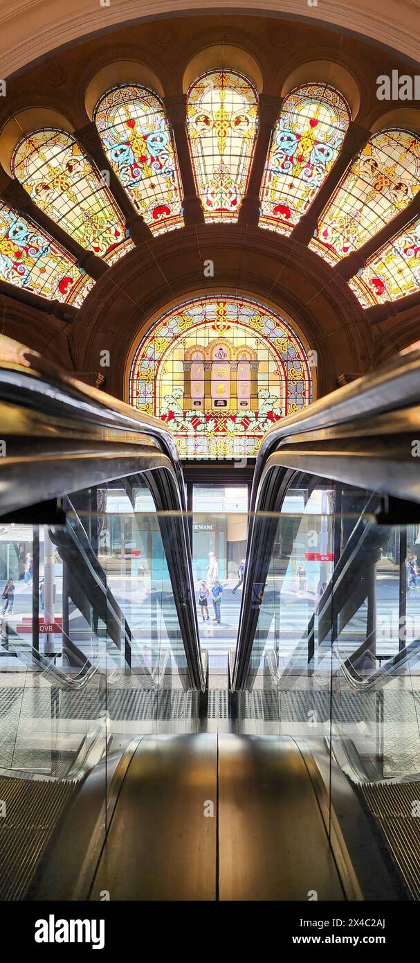 vertical photo of an escalator seen from above, in beautiful light ...