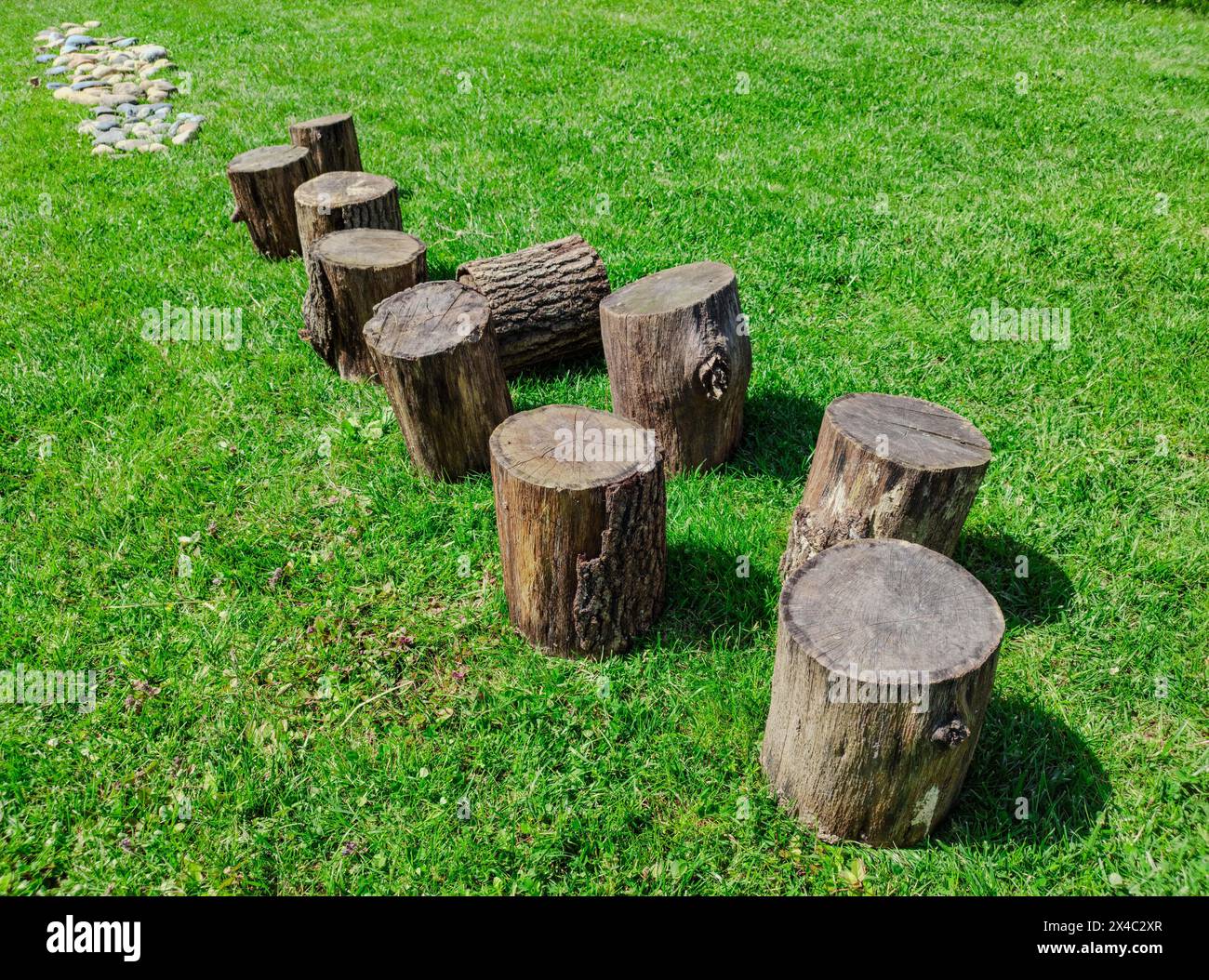 A route to be done barefoot: wooden logs on a lawn followed by one of ...