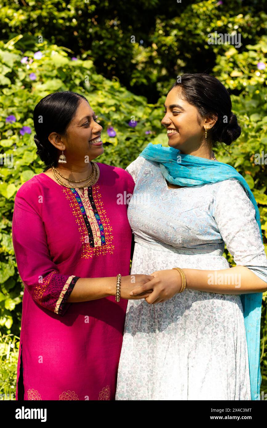 Indian mother and teenage daughter, wearing traditional clothes ...