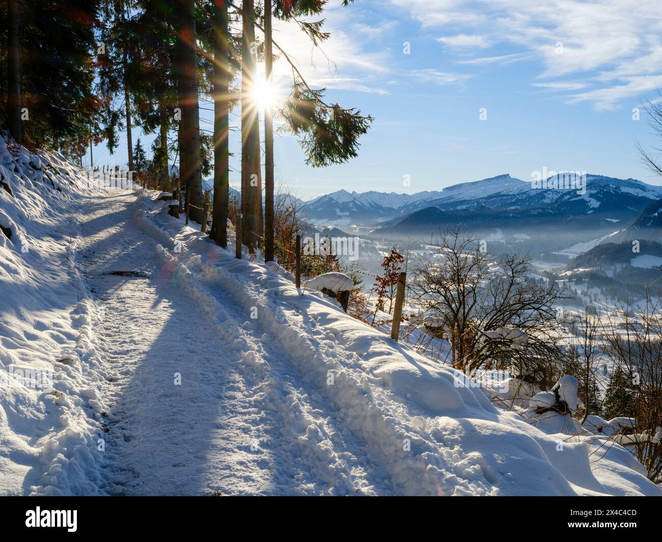 Snowy track above the valley of river Iller. The Allgau Alps near ...