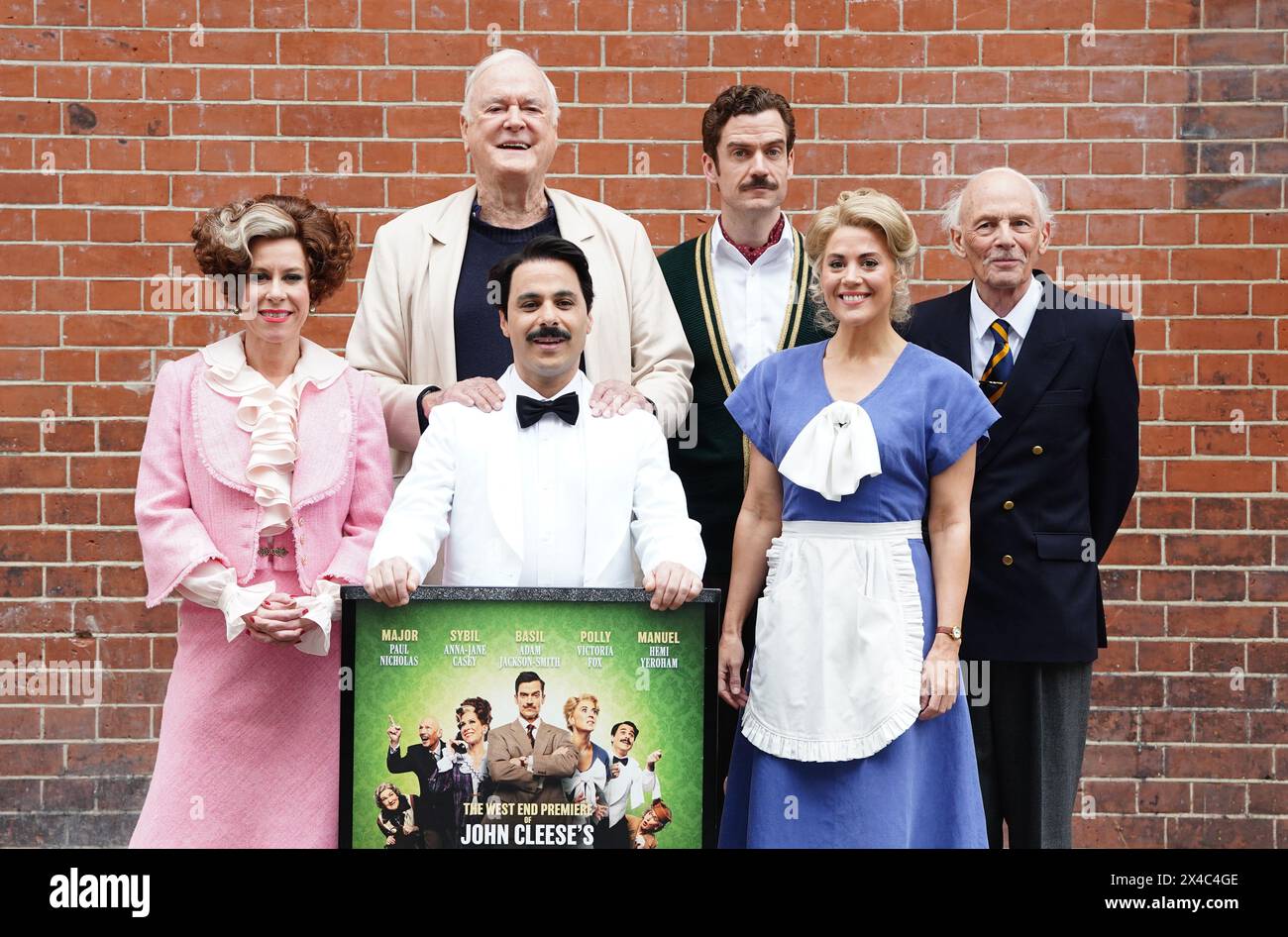 John Cleese (back row left) with (left to right) Anna-Jane Casye as ...