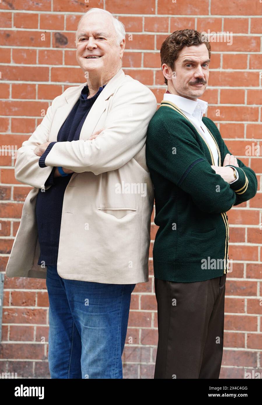 John Cleese with Adam Jackson-Smith as Basil Fawlty pose before a Q&A ...