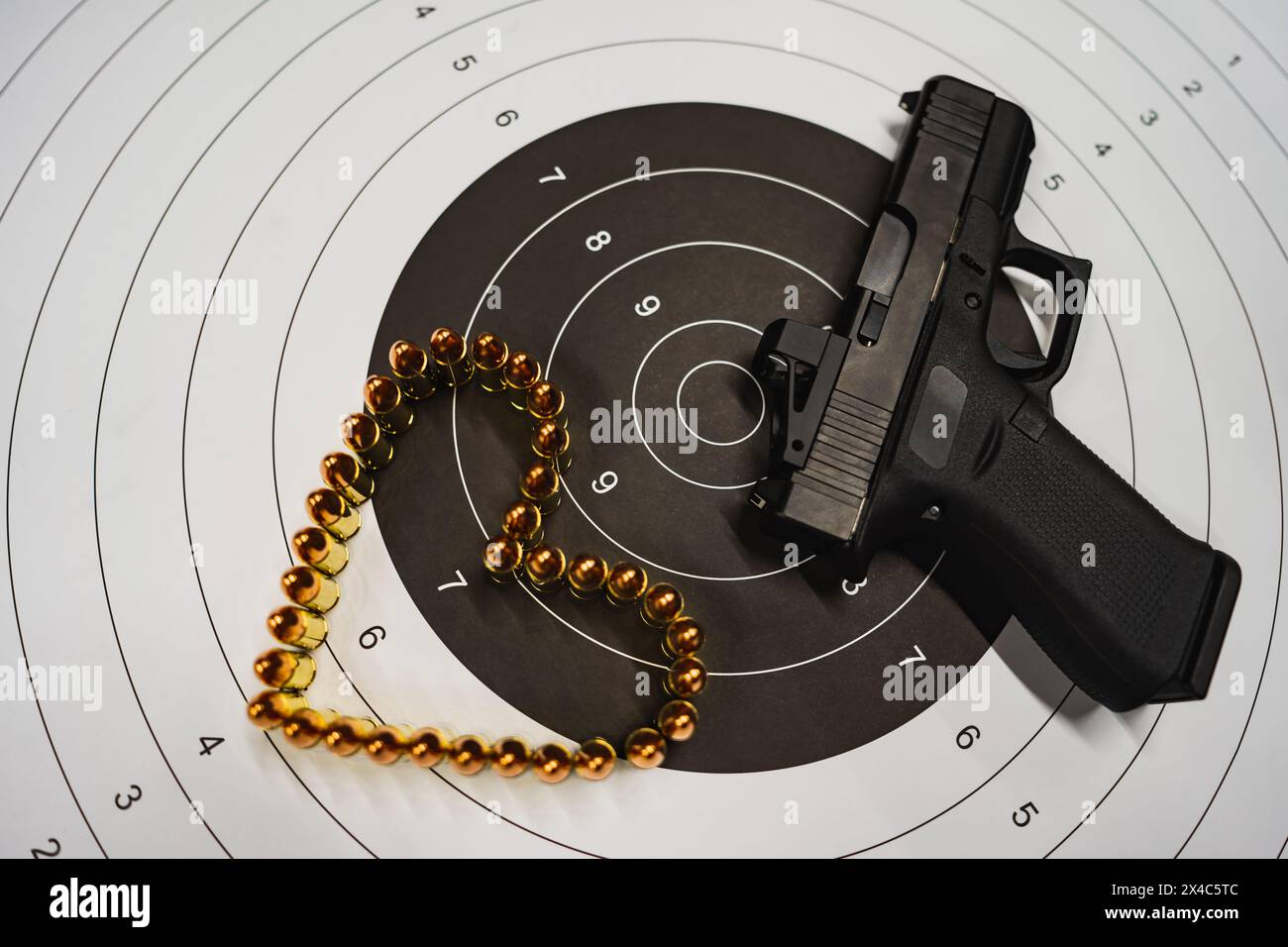 Firearm, modern 9mm compact pistol with red dot, paper target and heart ...