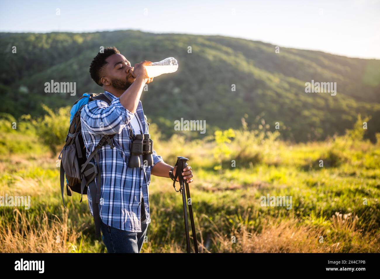 Young man drinking water walking hi-res stock photography and images ...